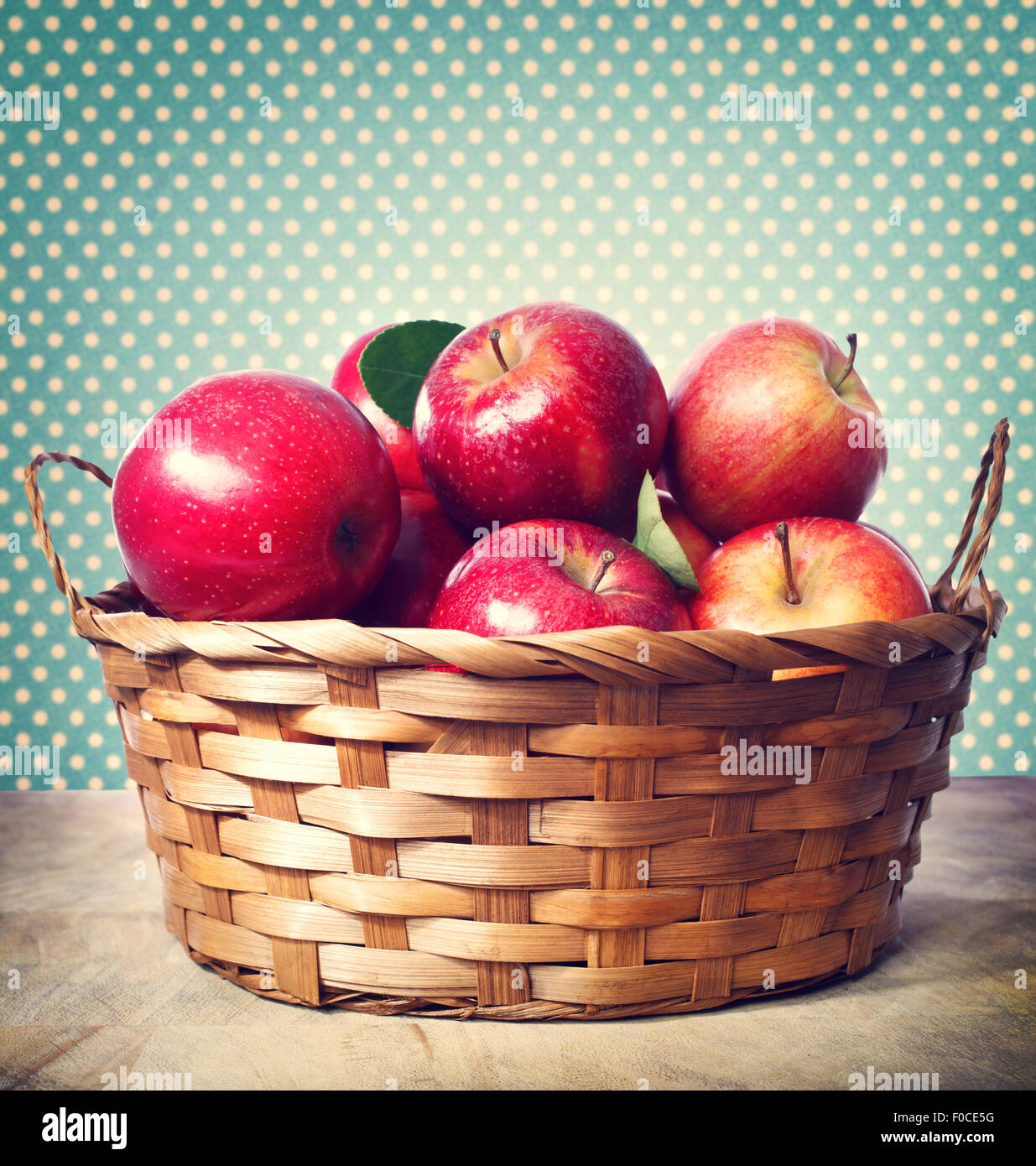 Red apples in basket over polka dots background in vintage style Stock ...