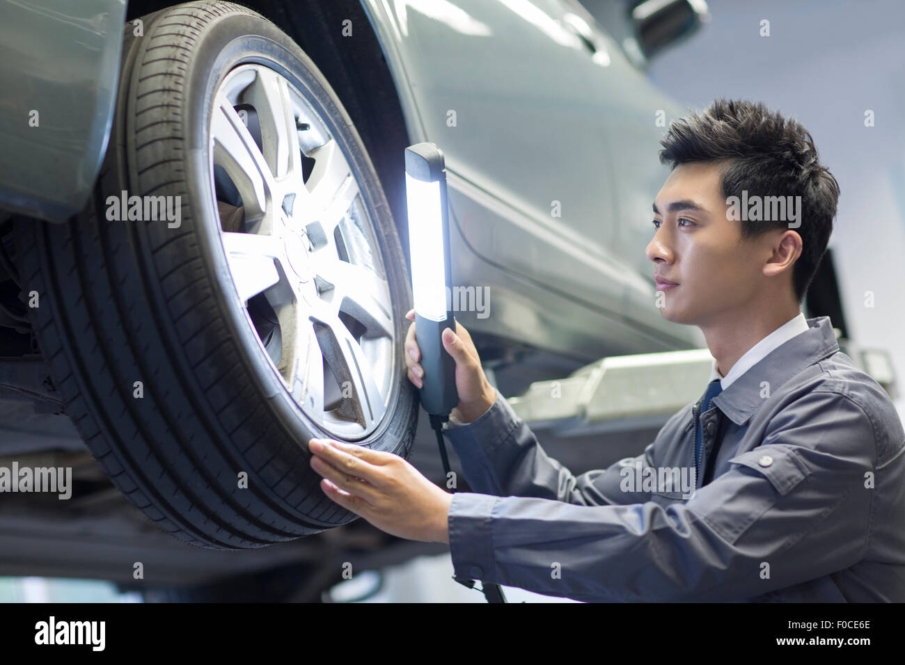 Standing car mechanic transportation industry manufacturing manual ...