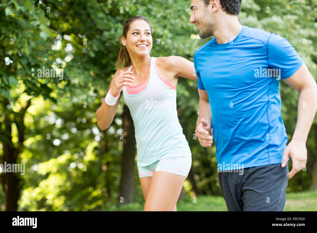 Young couple running in the park Stock Photo - Alamy