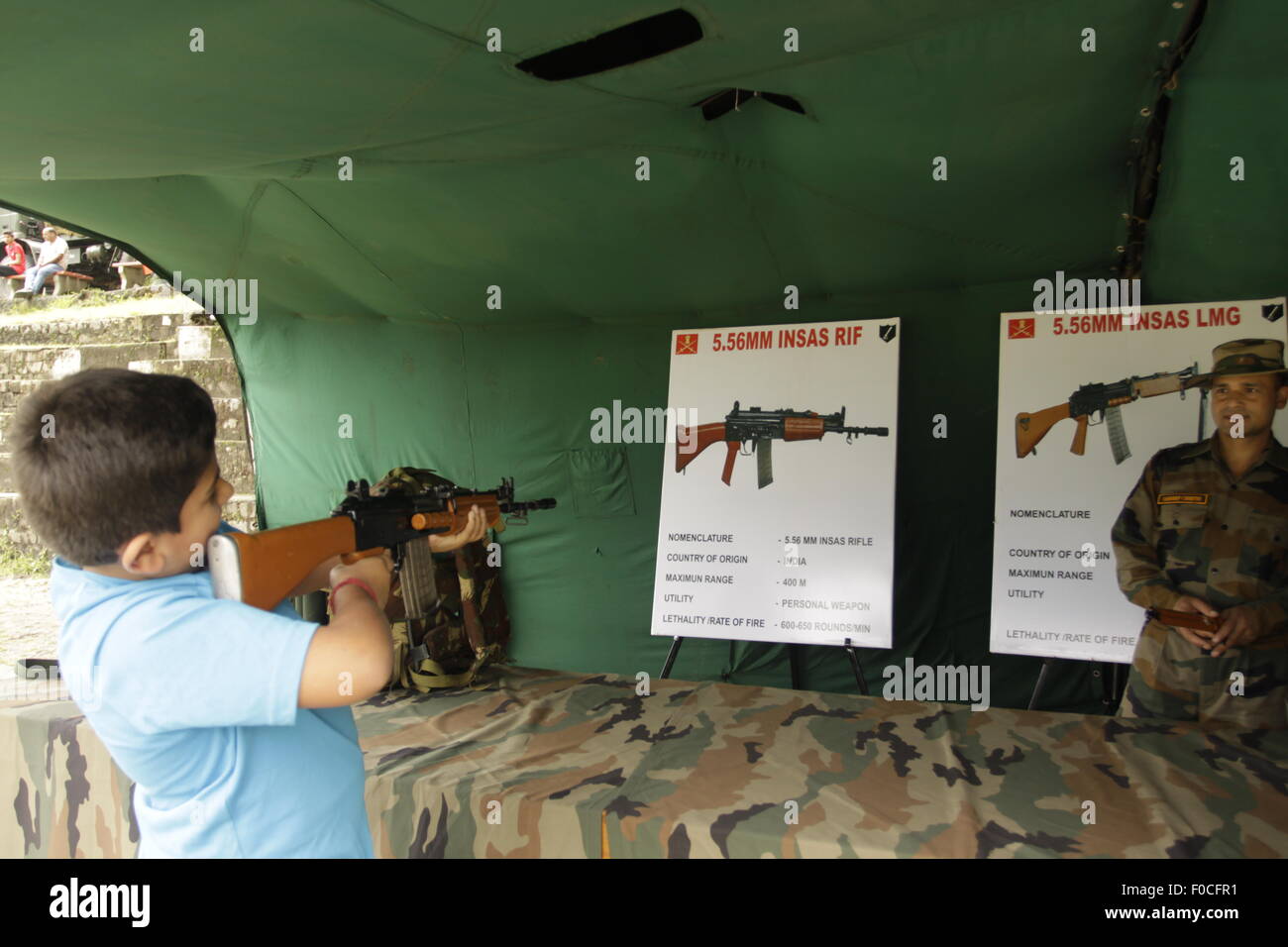 Palampur, India. 12th Aug, 2015. Young boy trying to hold INSAS (Indian ...