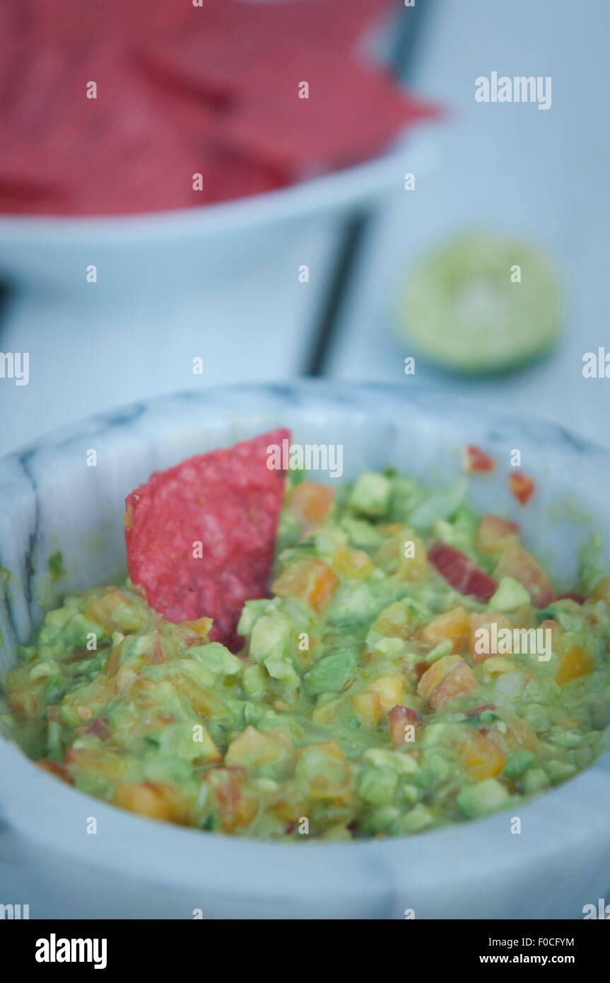 Guacamole with red tortilla chips Stock Photo - Alamy