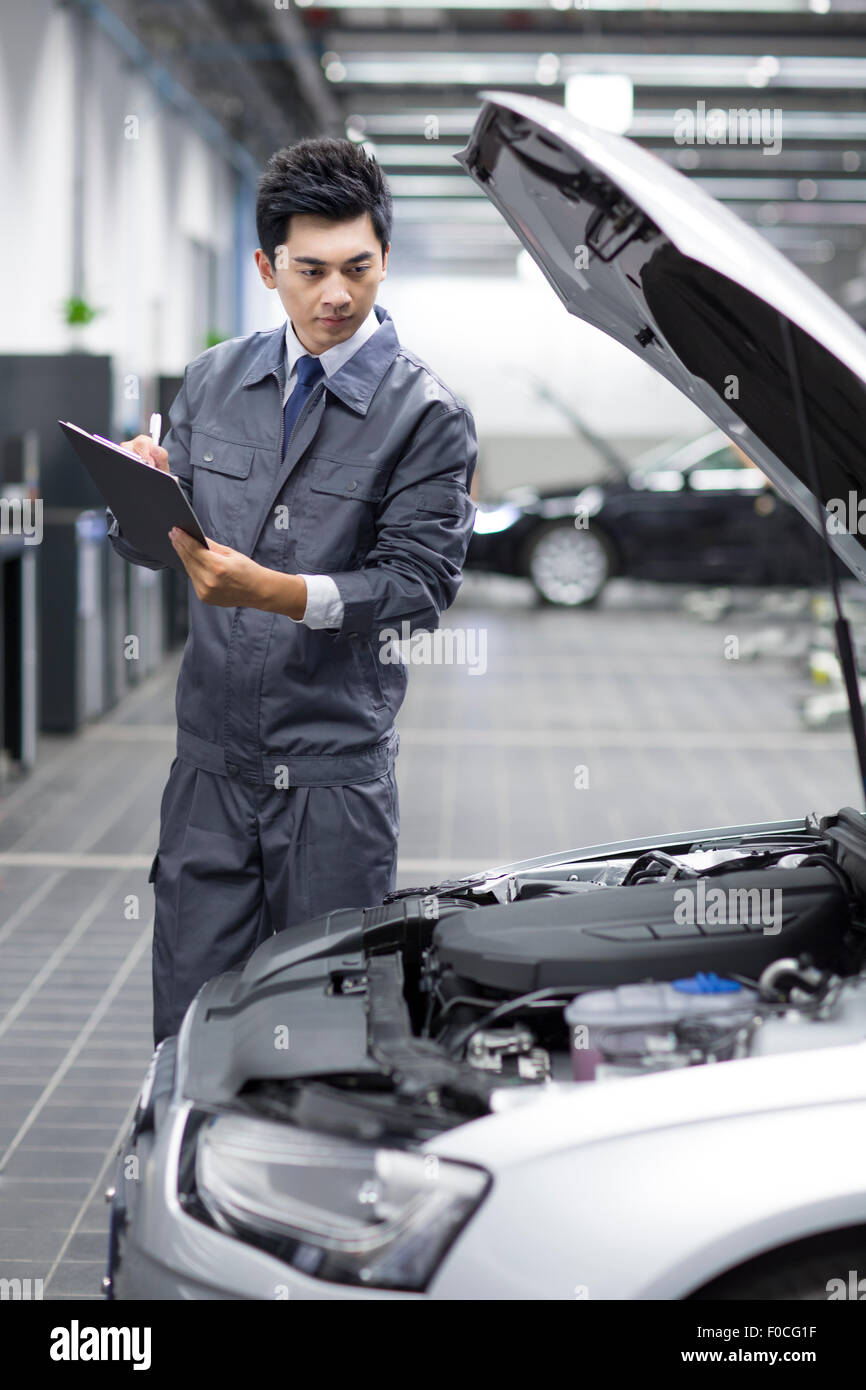 Standing car mechanic transportation industry manufacturing manual ...