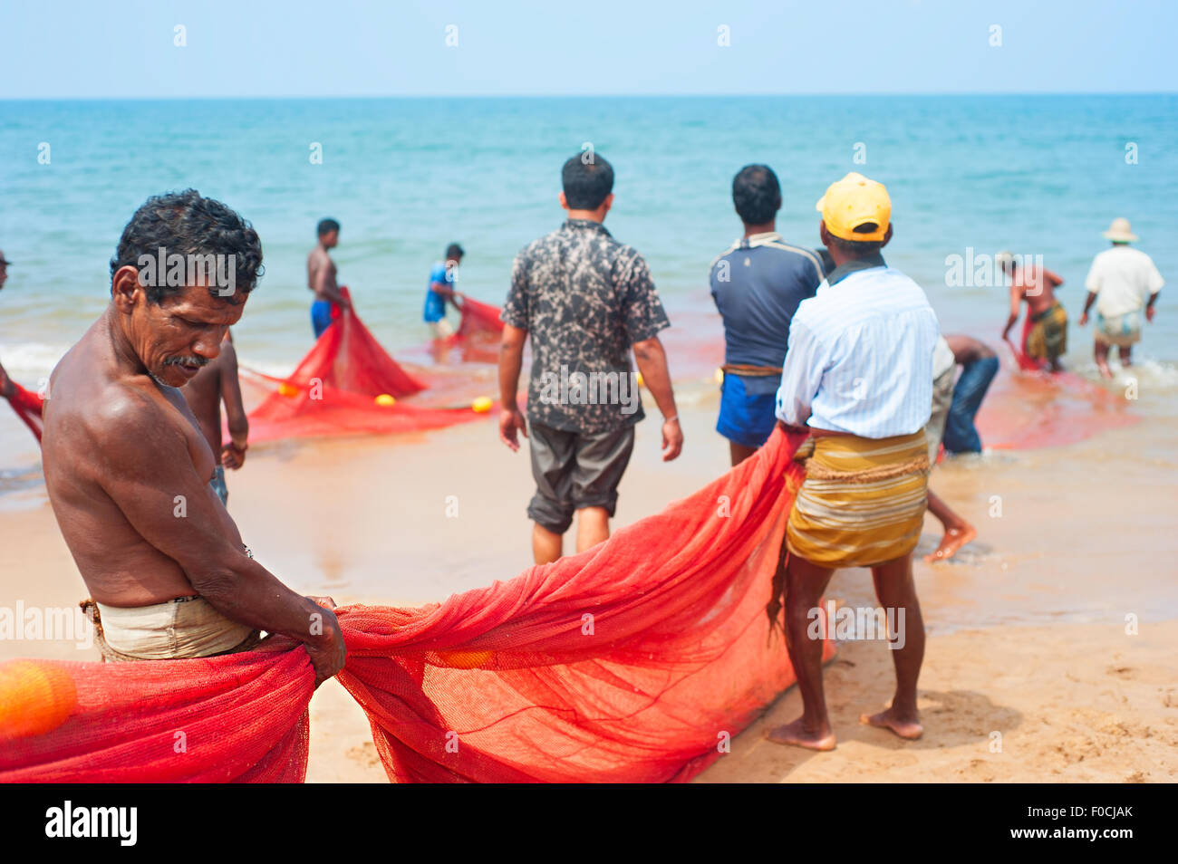 Local fisherman pull net from the ocean Stock Photo - Alamy