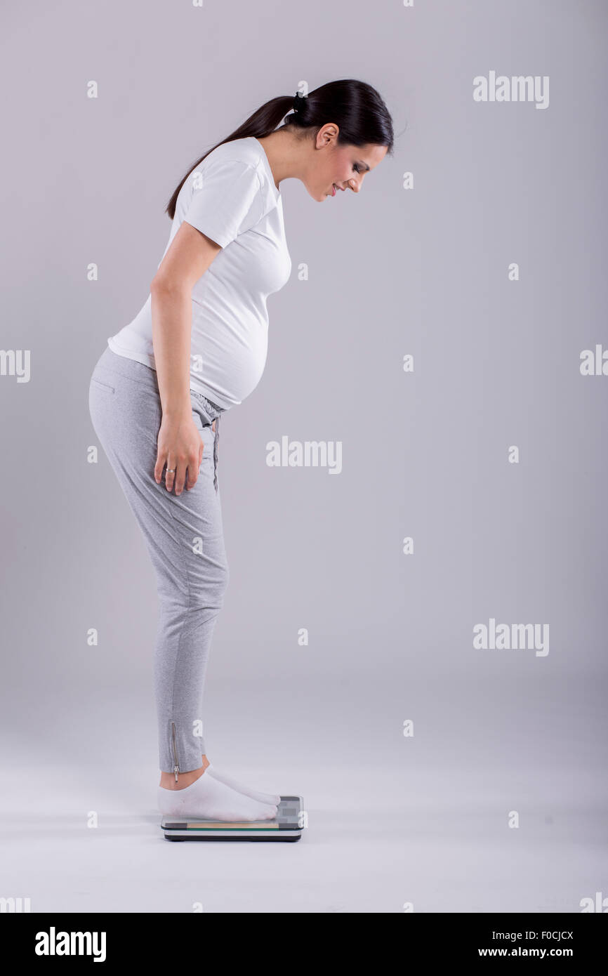 Young pregnant woman checking weight Stock Photo - Alamy