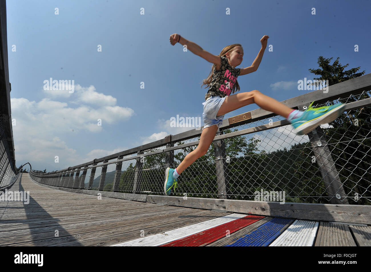9-years old Lilli jumps over the landmark between Germany and Austria ...