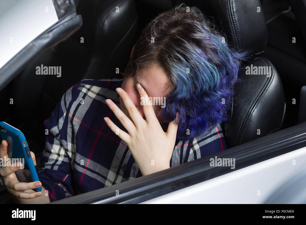 Teenage girl showing depression with cell phone in hand Stock Photo - Alamy