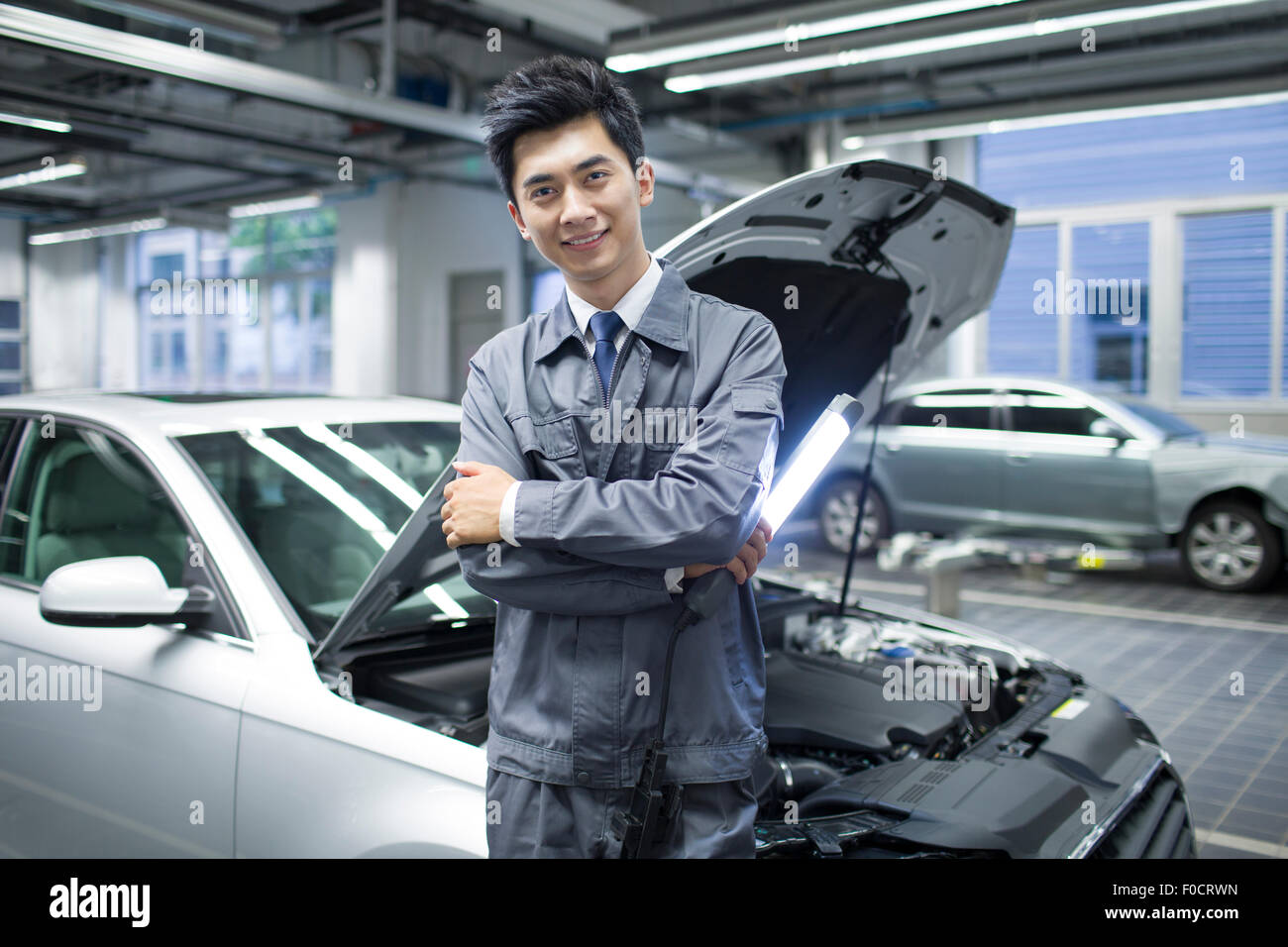 Standing car mechanic transportation industry manufacturing manual ...