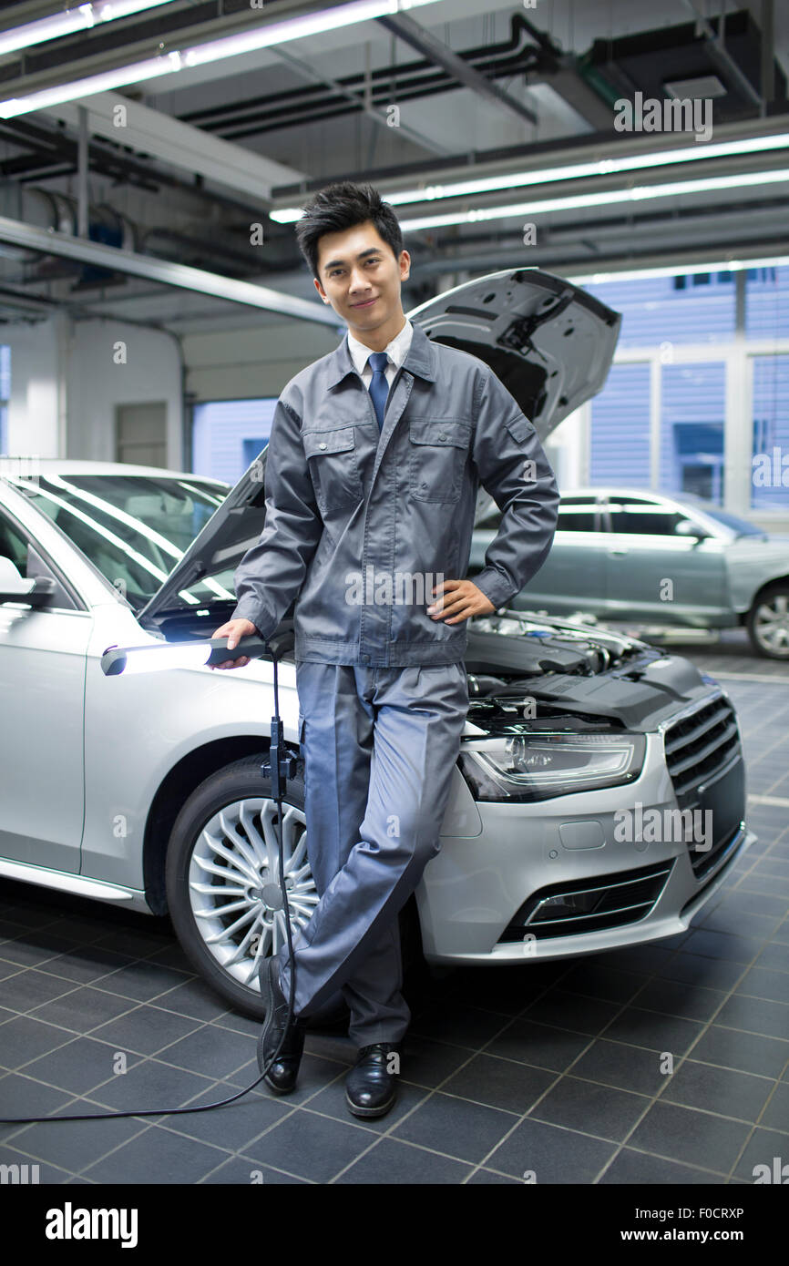 Standing car mechanic transportation industry manufacturing manual ...