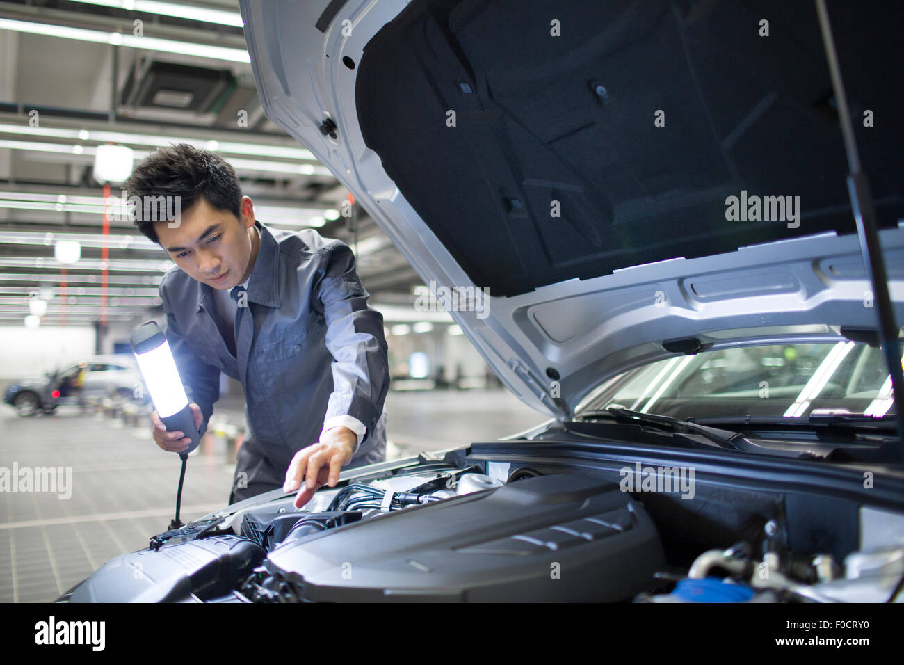 Standing car mechanic transportation industry manufacturing manual ...