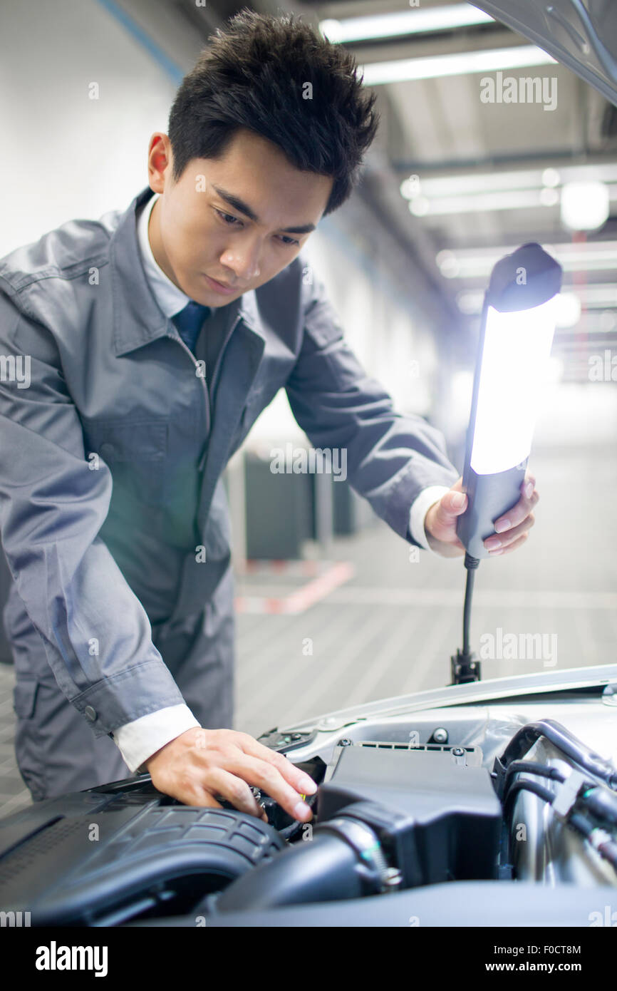 Standing car mechanic transportation industry manufacturing manual ...