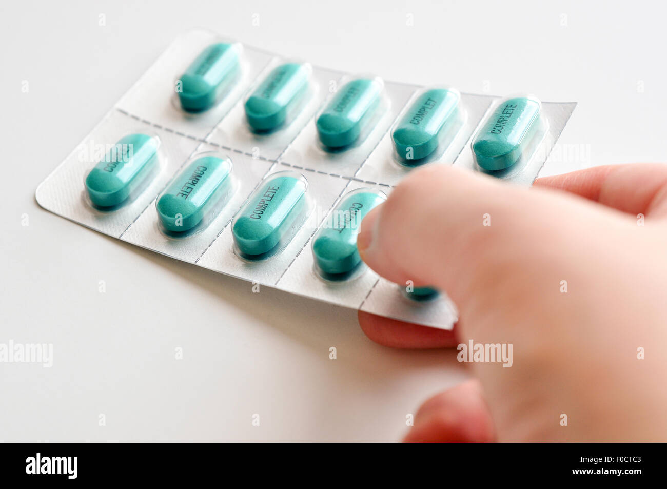 Hand holding tablet packing medicine Stock Photo - Alamy