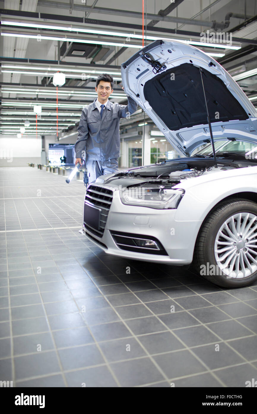 Standing car mechanic transportation industry manufacturing manual ...