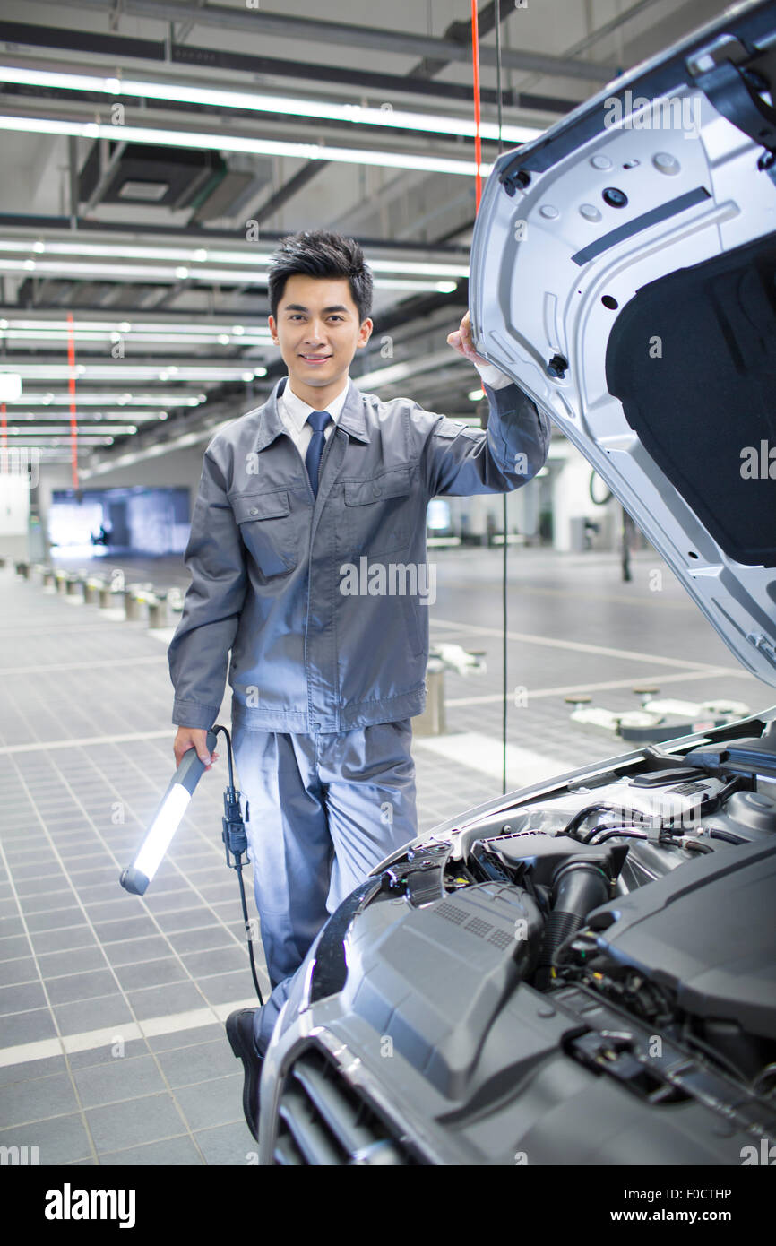 Standing car mechanic transportation industry manufacturing manual ...