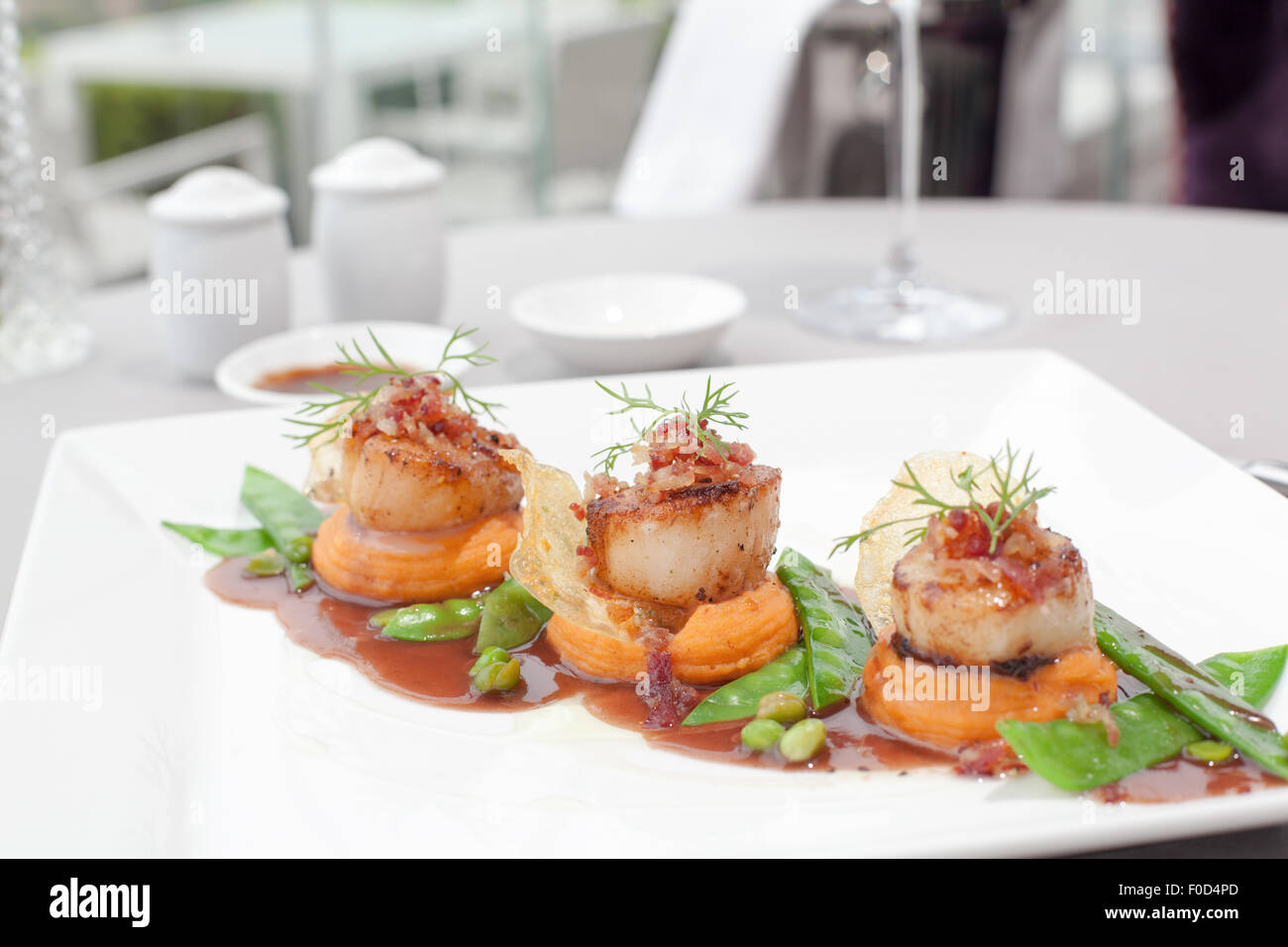 Grilled Scallops with green red wine in restaurant Stock Photo - Alamy