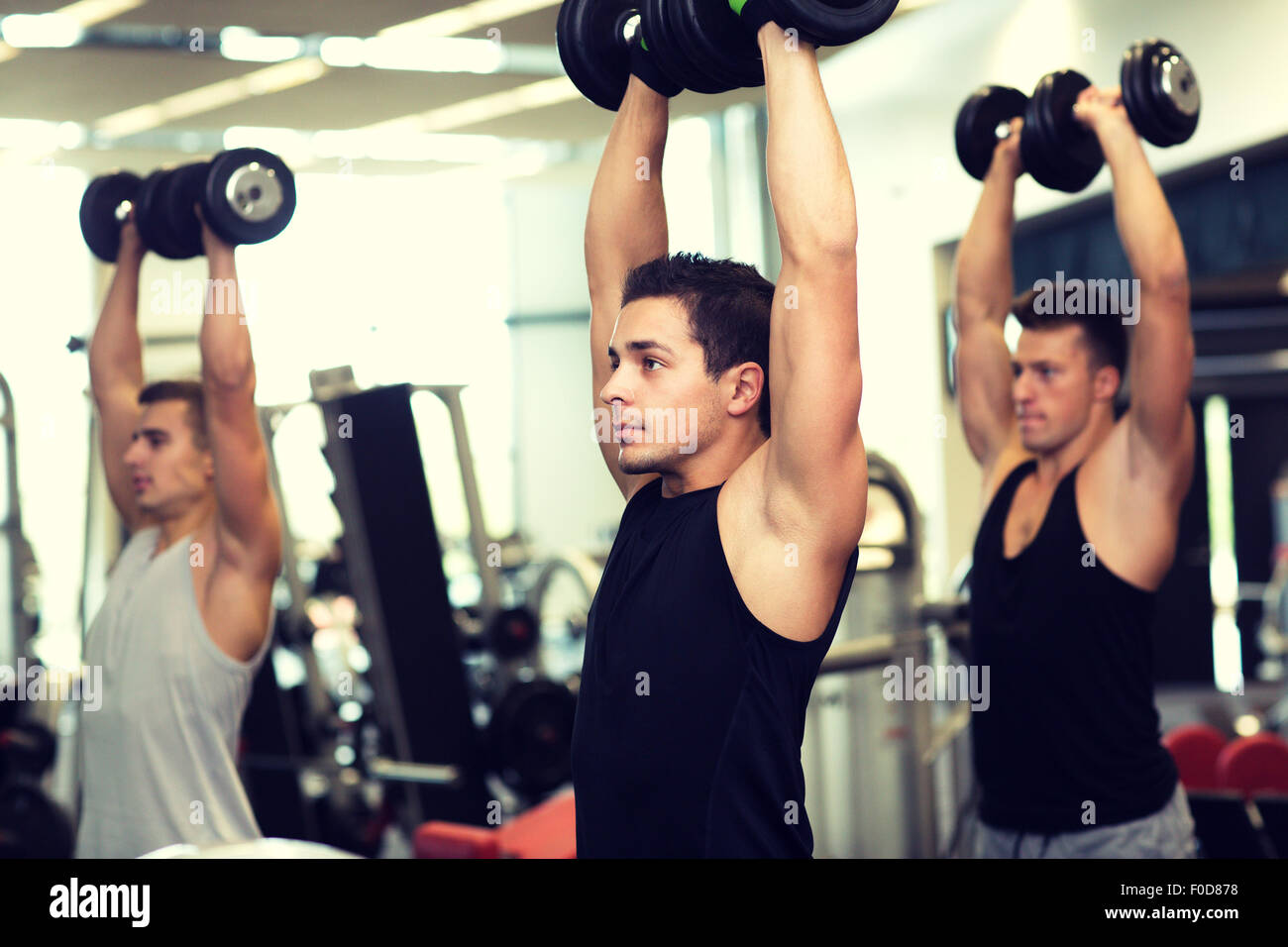 group of men with dumbbells in gym Stock Photo - Alamy
