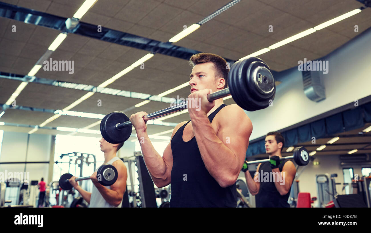 group of men flexing muscles with barbell in gym Stock Photo - Alamy