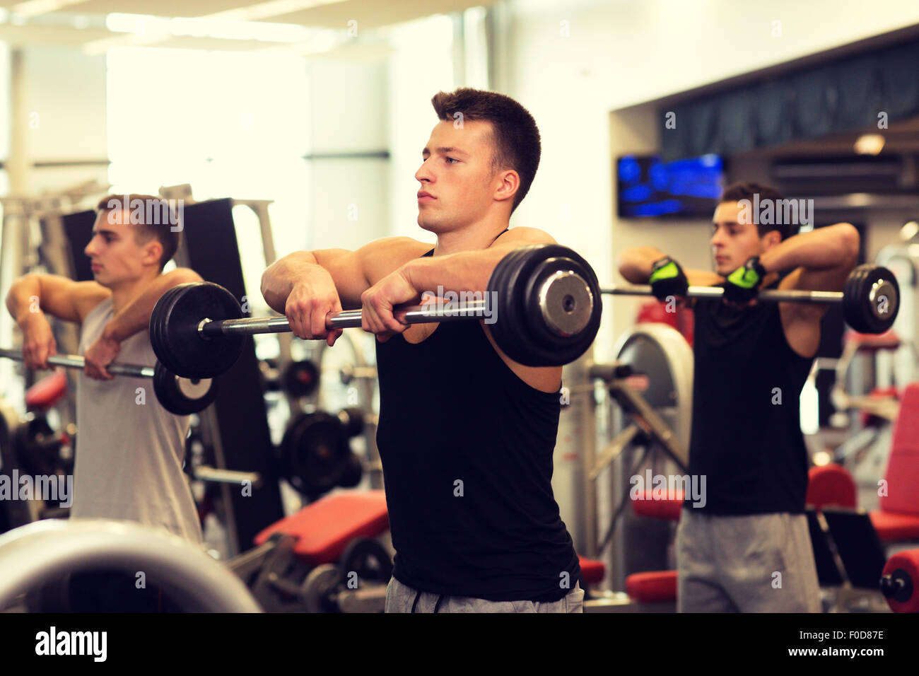group of men with barbells in gym Stock Photo - Alamy