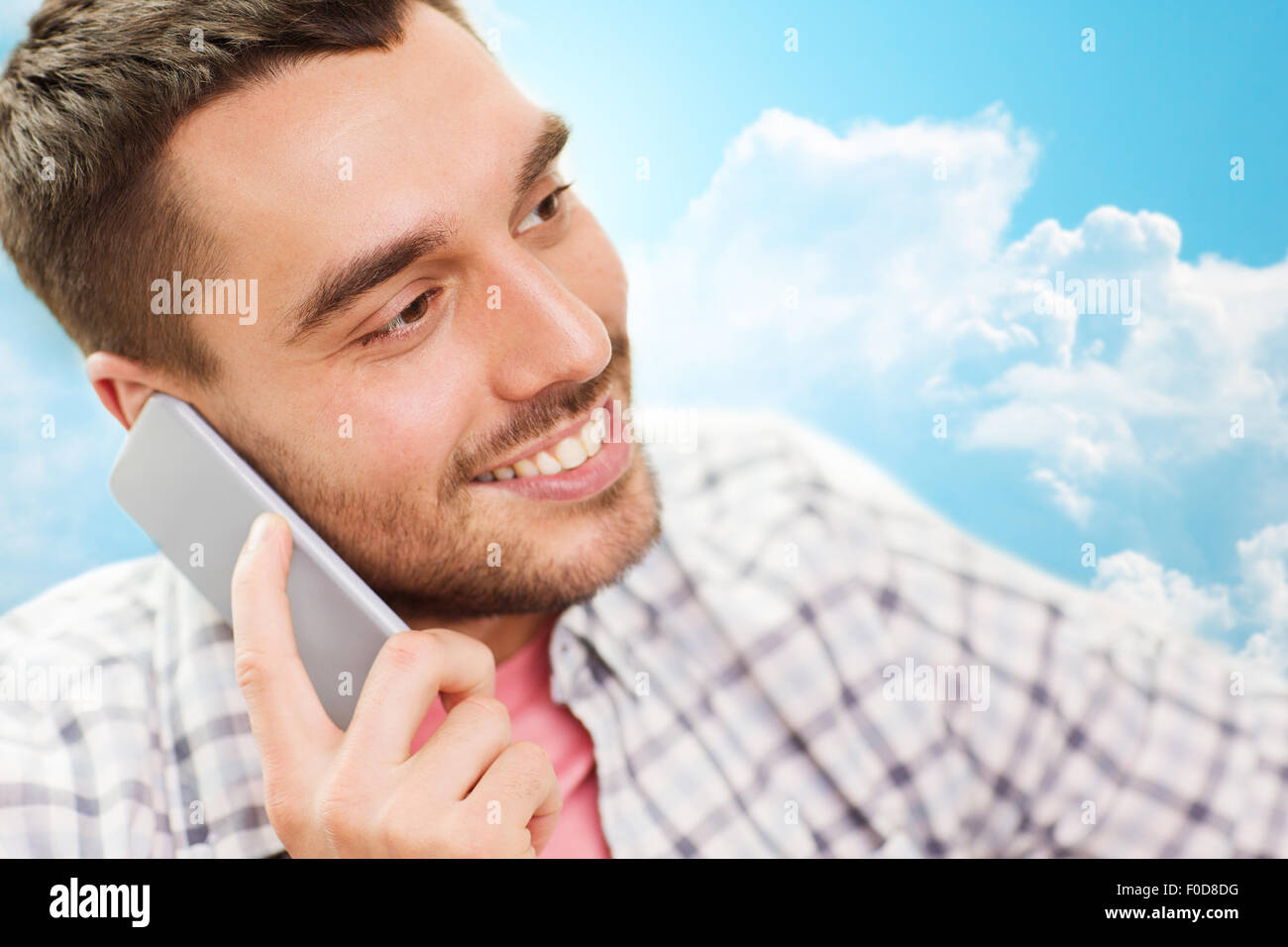 smiling young man calling on smartphone Stock Photo - Alamy
