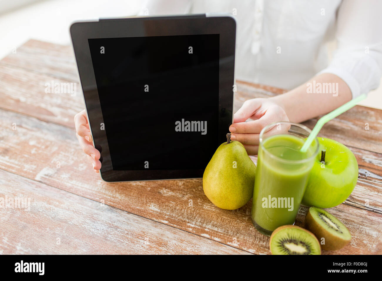 close up of woman hands tablet pc and fruit juice Stock Photo - Alamy