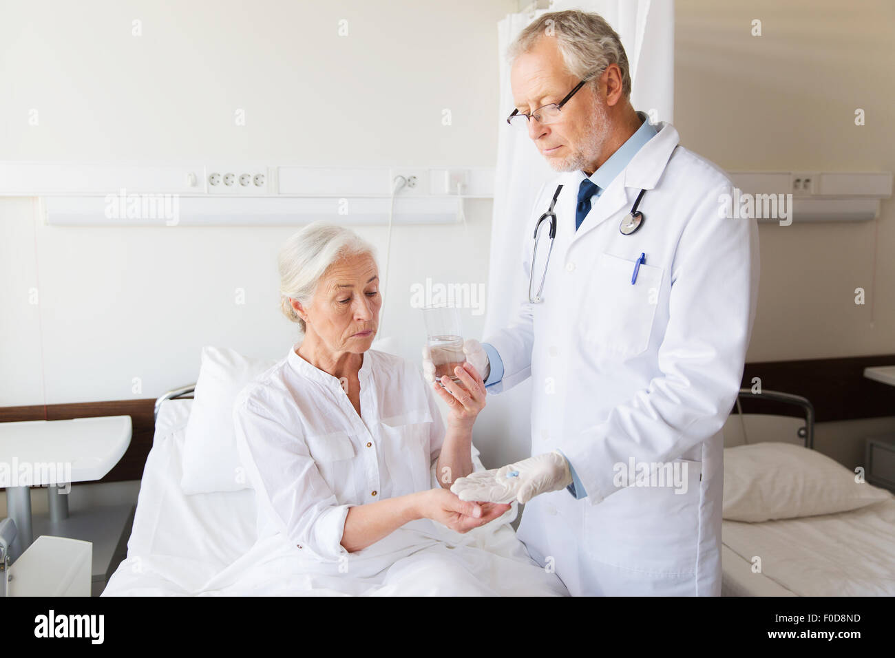 doctor giving medicine to senior woman at hospital Stock Photo - Alamy