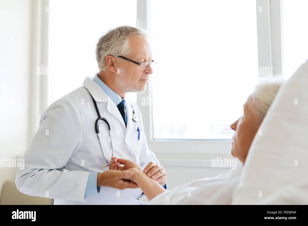 doctor checking senior woman pulse at hospital Stock Photo - Alamy
