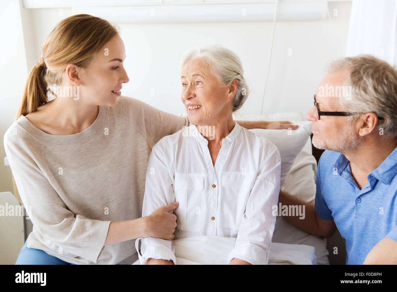 happy family visiting senior woman at hospital Stock Photo - Alamy