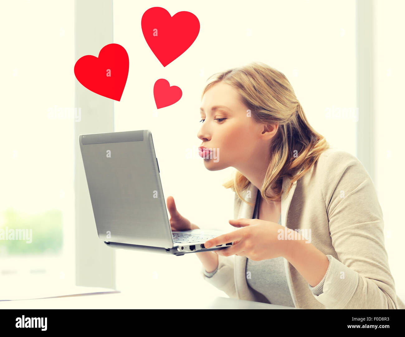 woman sending kisses with laptop computer Stock Photo - Alamy