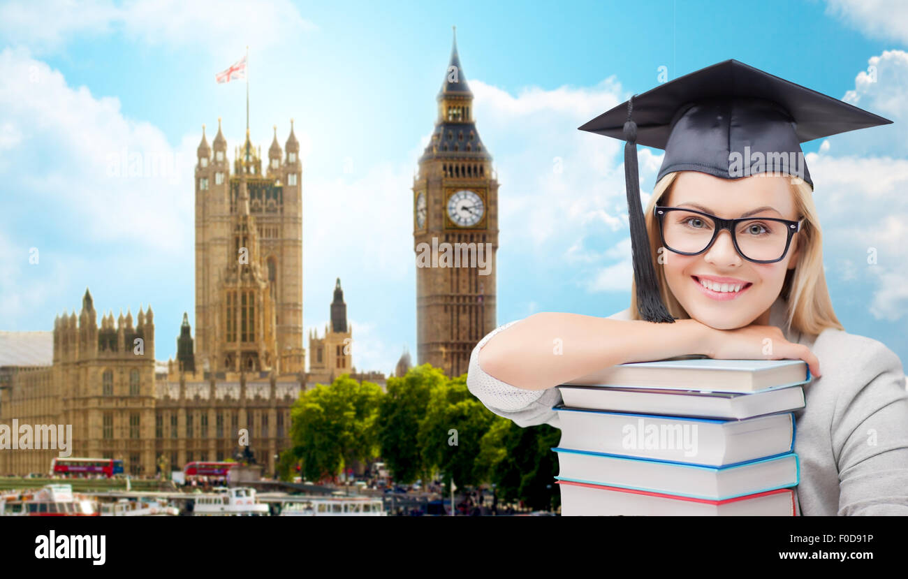 student in trencher cap with books over london Stock Photo - Alamy