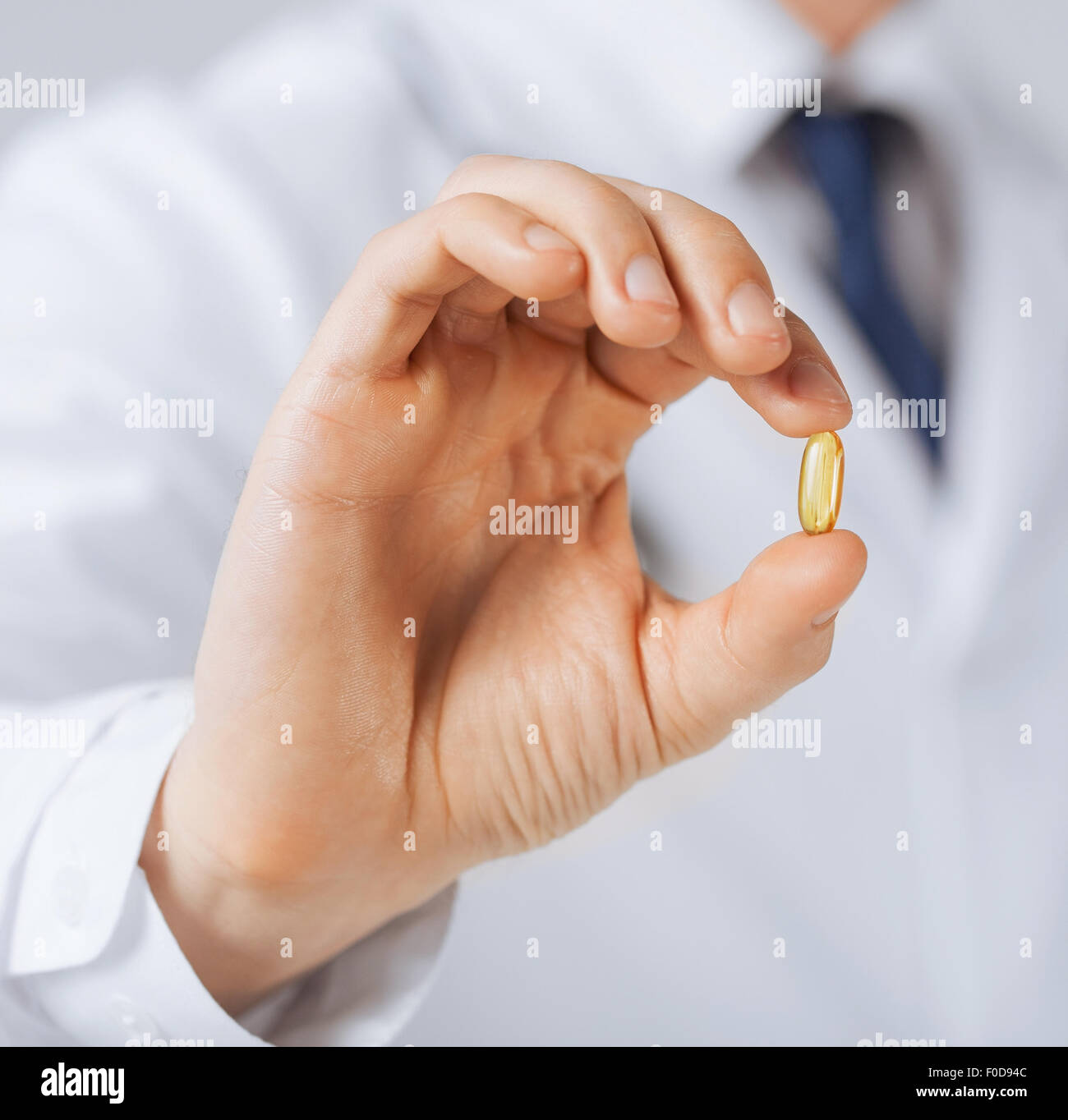 doctor hand showing one capsule Stock Photo - Alamy