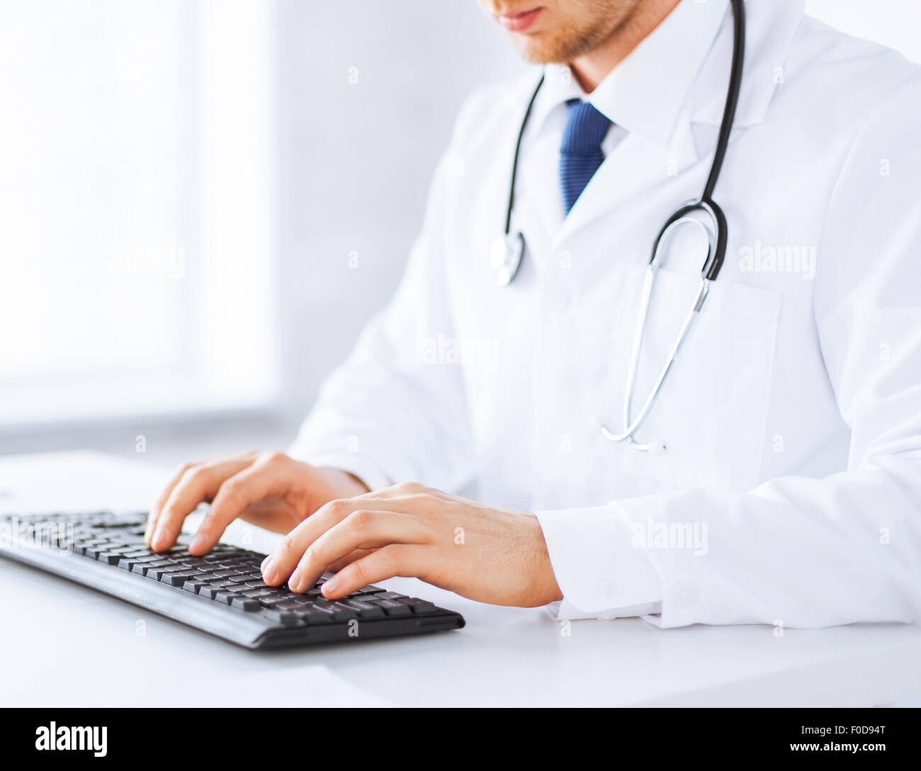 male doctor typing on the keyboard Stock Photo - Alamy