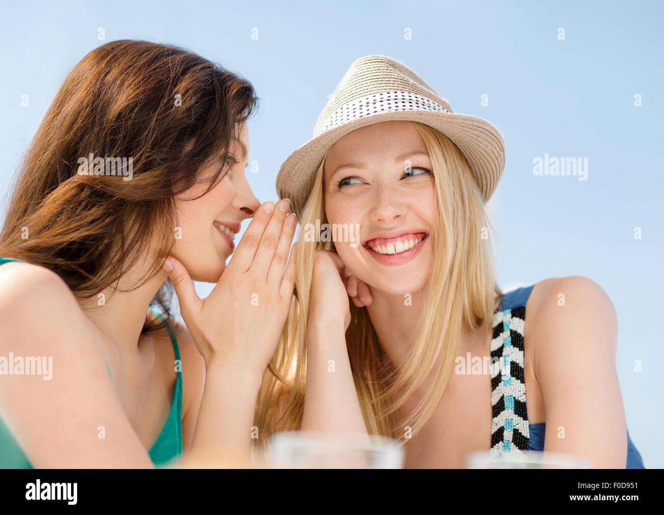 girls gossiping in cafe on the beach Stock Photo - Alamy