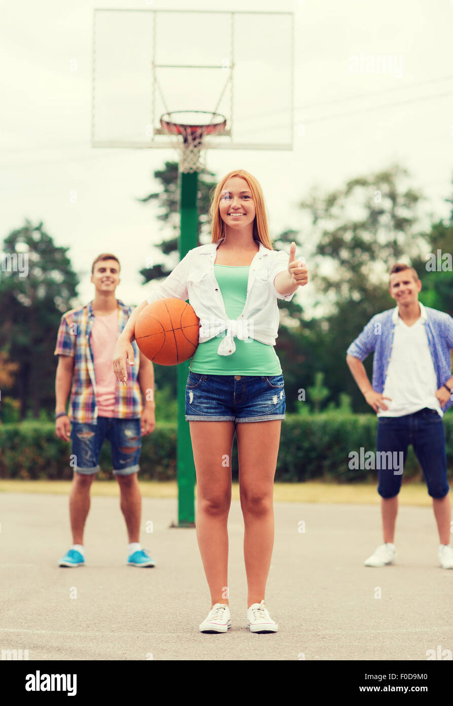 group of smiling teenagers playing basketball Stock Photo - Alamy