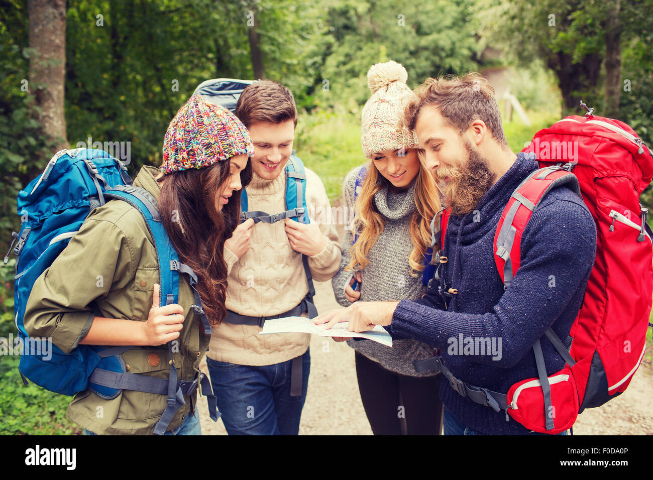 group of smiling friends with backpacks hiking Stock Photo - Alamy