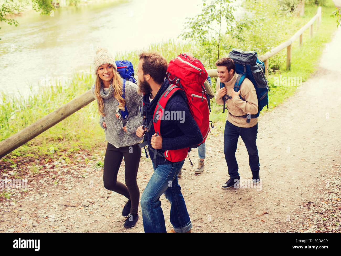 group of smiling friends with backpacks hiking Stock Photo - Alamy