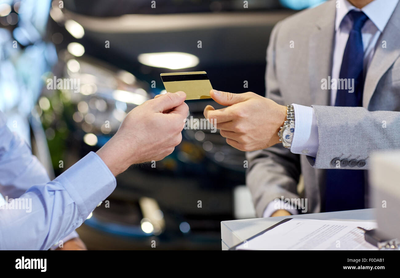 customer giving credit card to car dealer in salon Stock Photo - Alamy