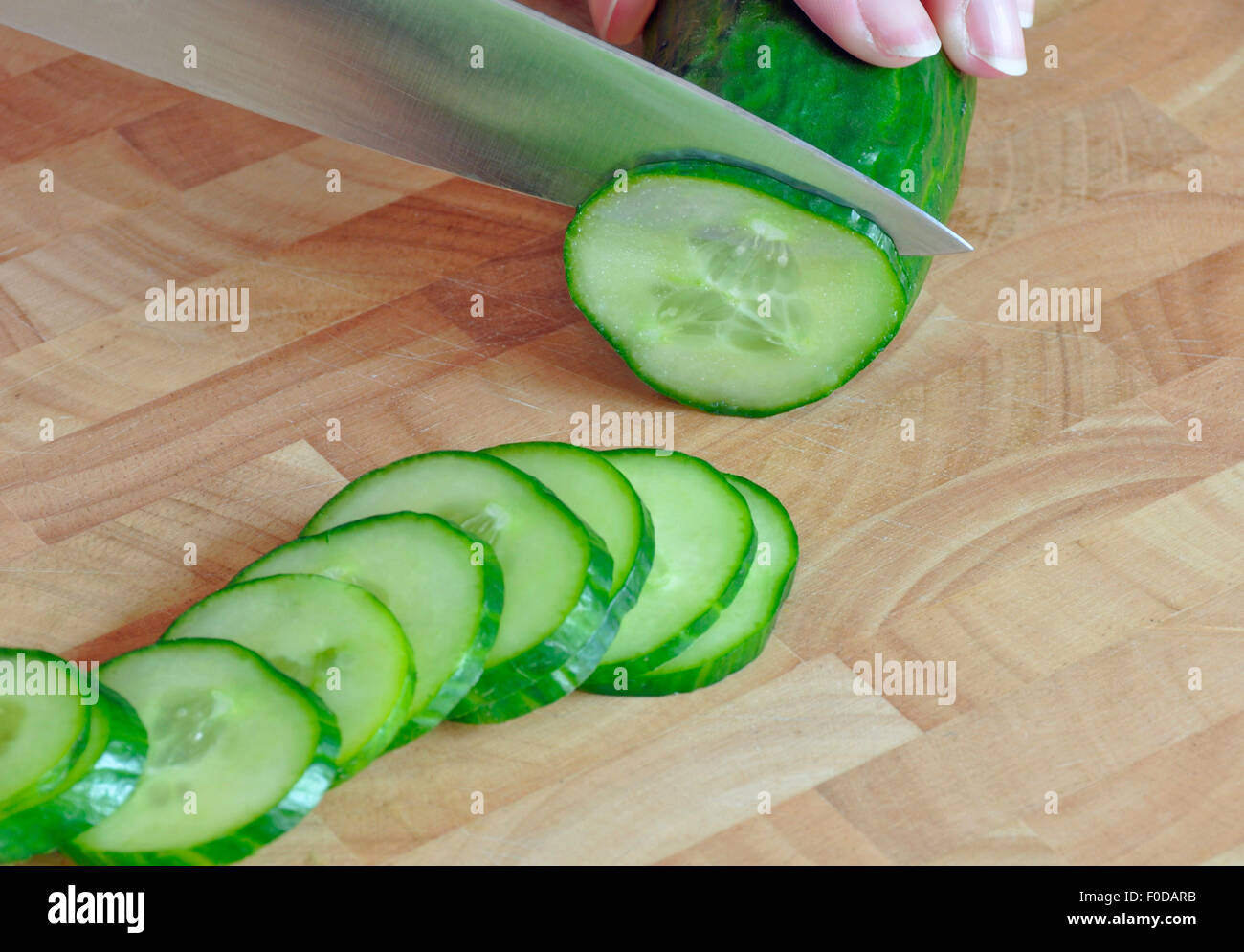 Female cutting cucumber into slices Stock Photo - Alamy