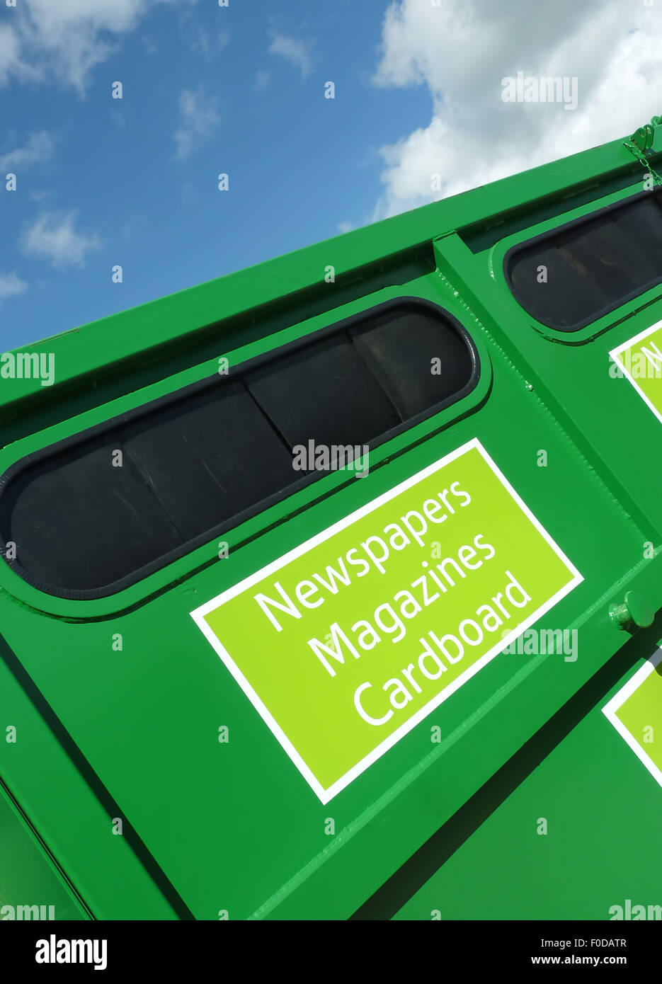 Closeup of green colored paper waste container Stock Photo - Alamy