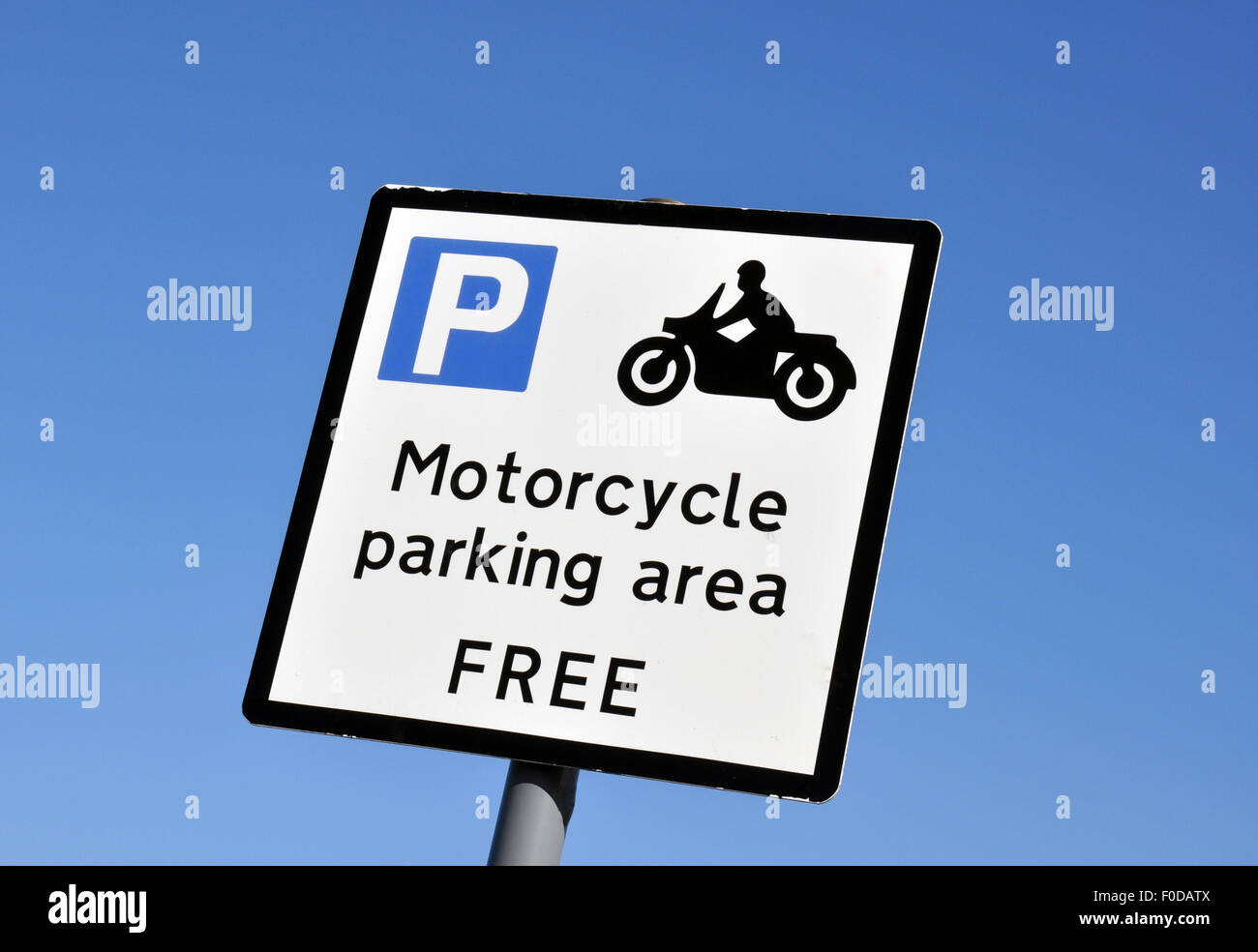 Motorcycle parking area sign against cloudless blue sky Stock Photo - Alamy