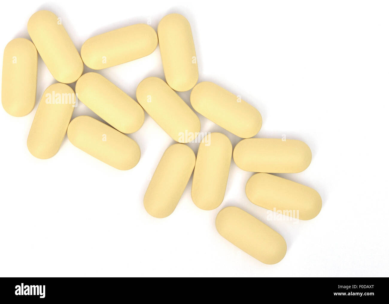 Yellow tablets on white Stock Photo - Alamy