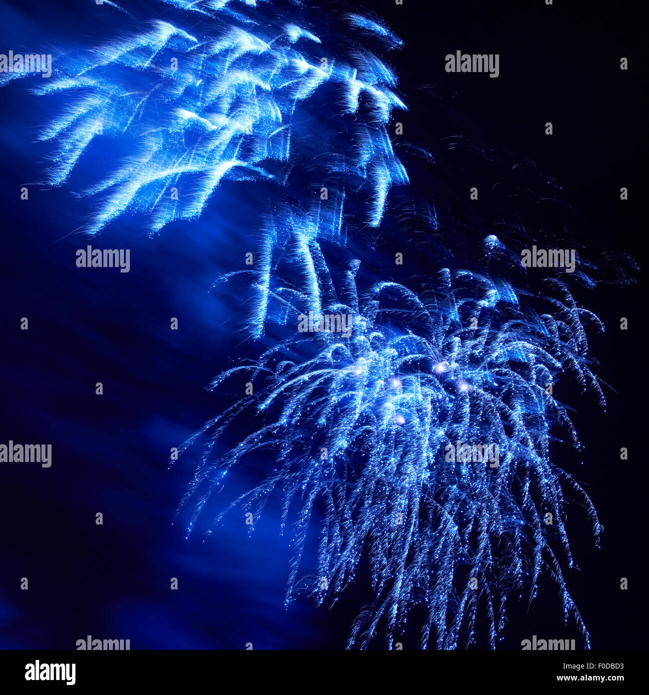 Blue colorful fireworks on the black sky background Stock Photo - Alamy