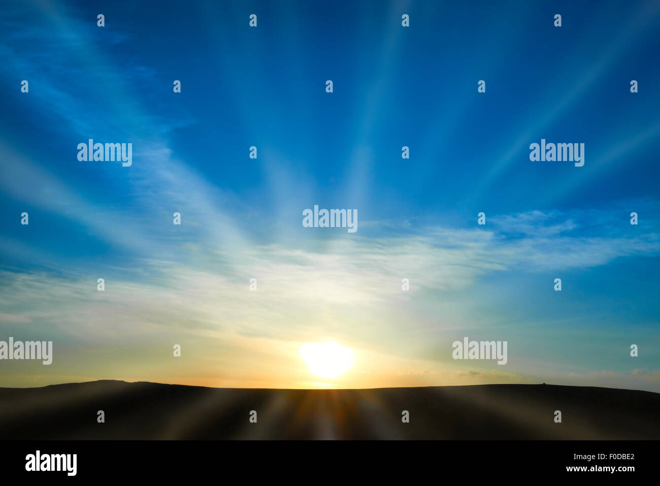 Sun rising above the land on blue sky. Nature background with sunny ...