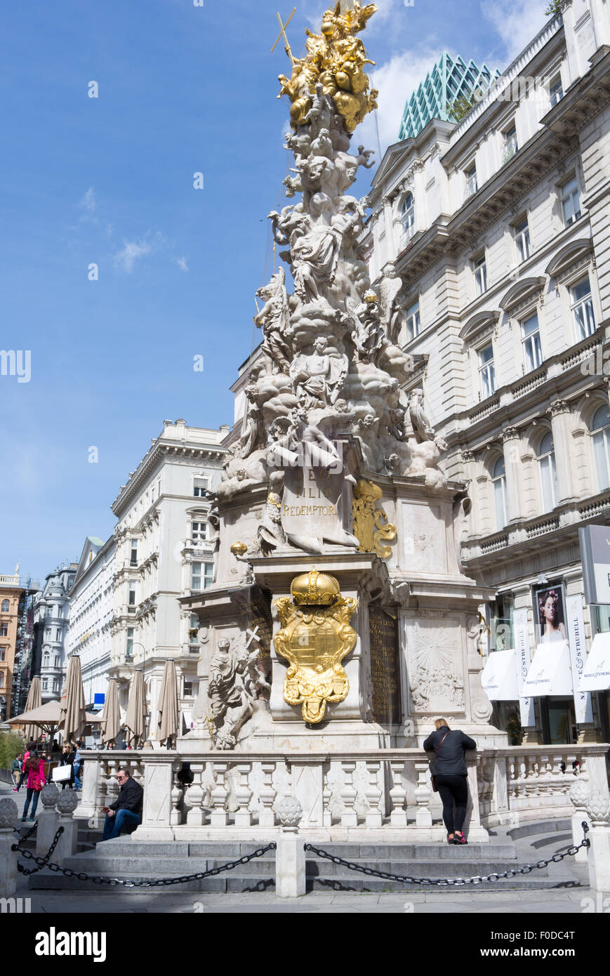 A tourist admires Vienna's Plague Column, built to celebrate the end of ...