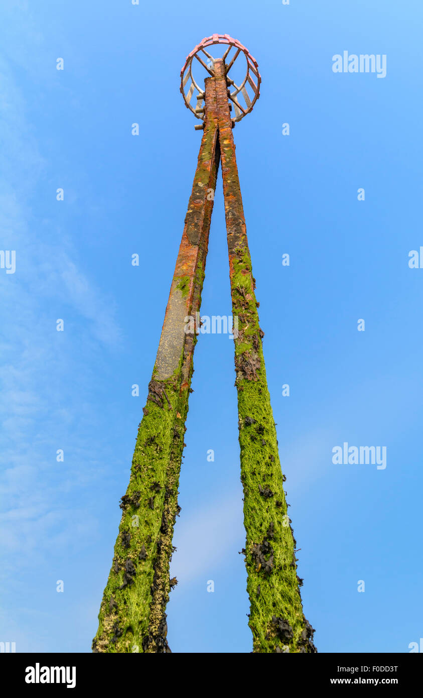 Tide marker at the seaside, looking upwards from the ground, against ...
