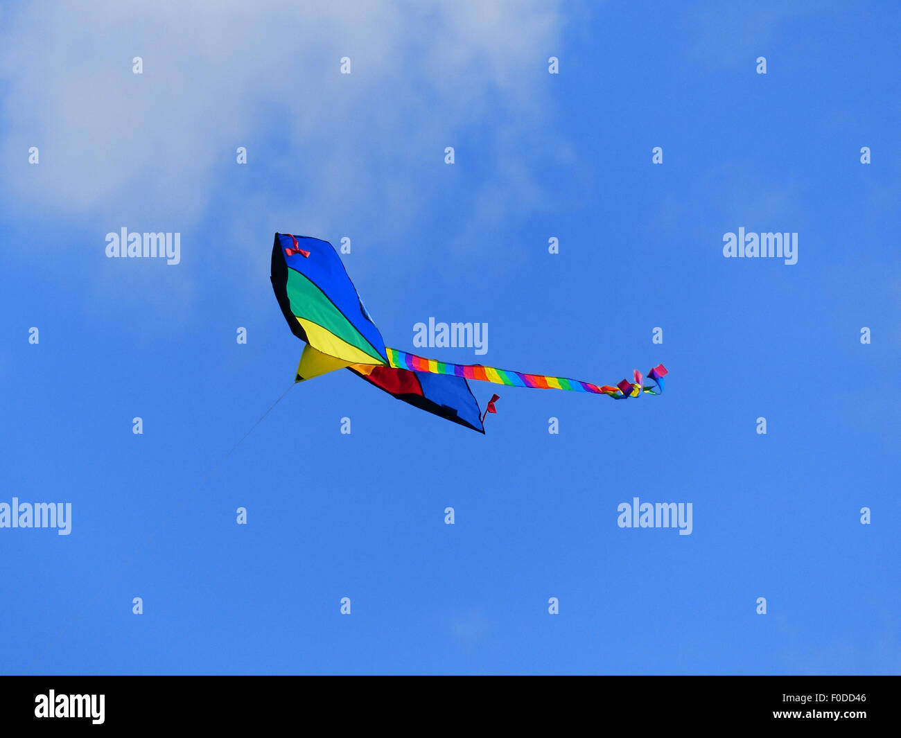 Colorful kite on a sunny day in blue cloudy skies Stock Photo - Alamy