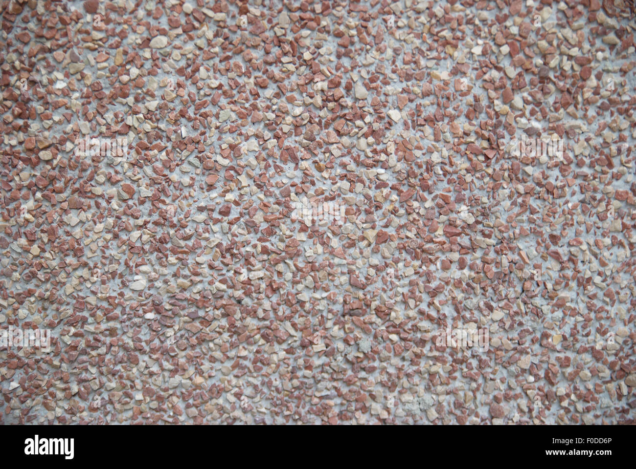 A wall of textured natural red stones Stock Photo - Alamy