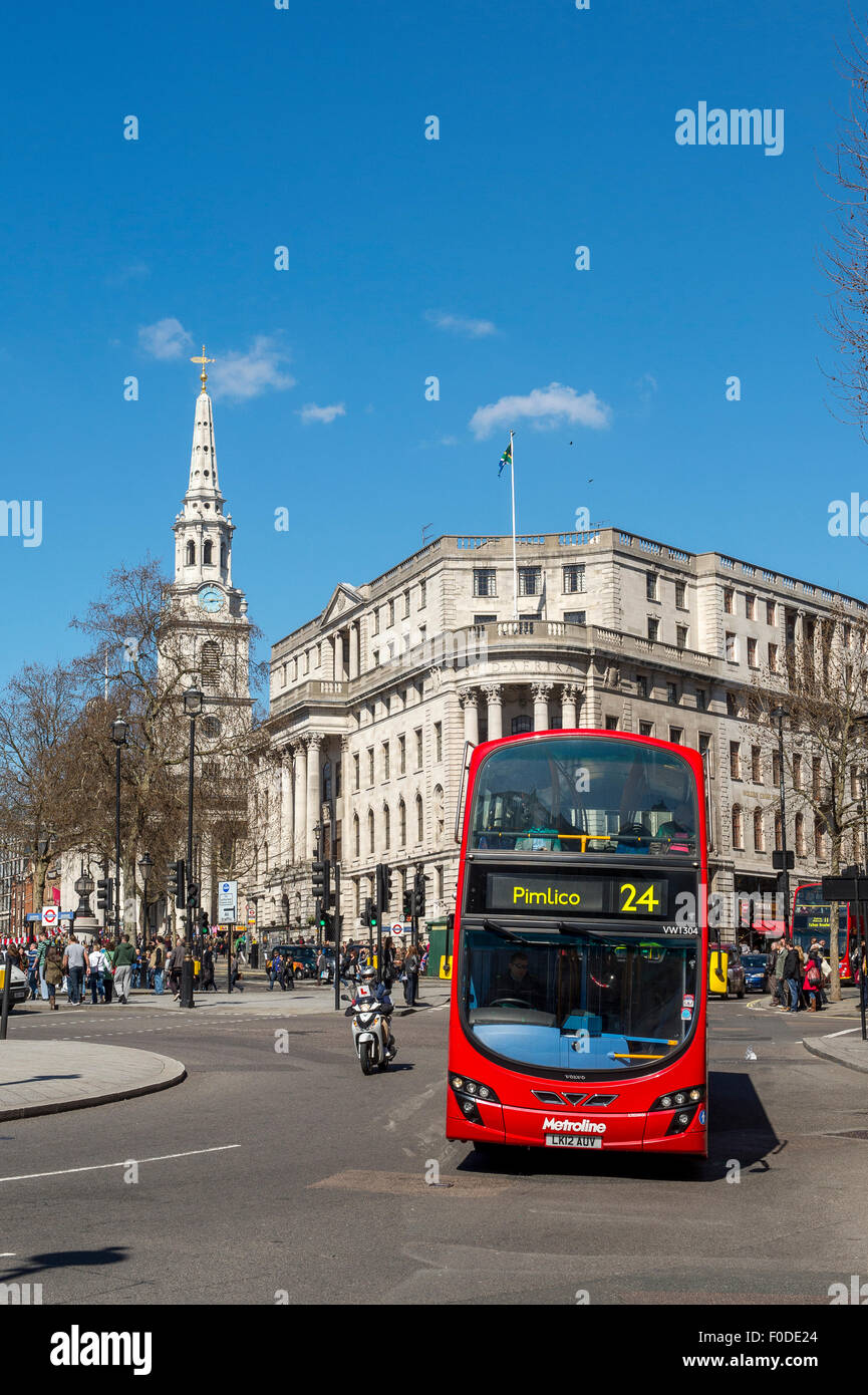 Double decker bus driving past Trafalgar Square in the City of London ...