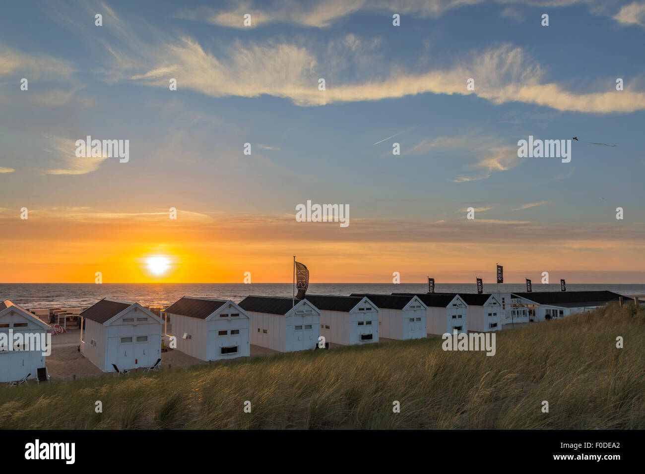 Lined-up summer cottages for hire with sunset view over the North Sea ...
