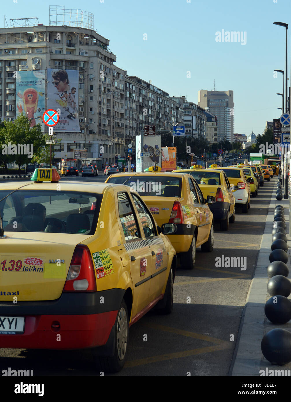 Romanian taxis sit at a taxi rank at Piata Unirii (Unification Square ...