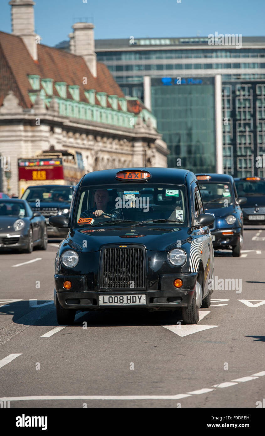 Black cab driving through the streets of the City of London, England ...