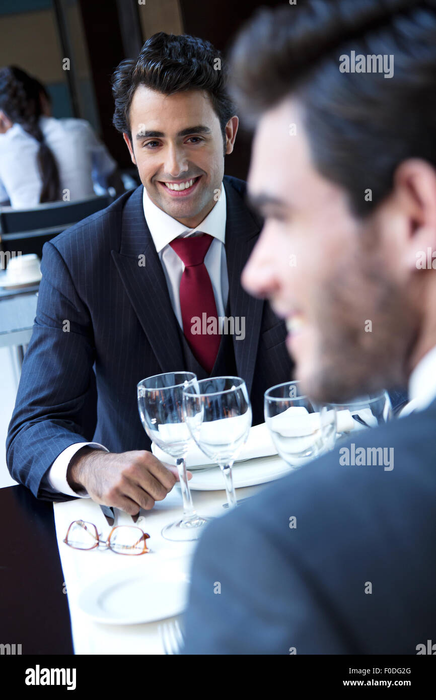 Two smiling business men have dinner at restaurant Stock Photo - Alamy